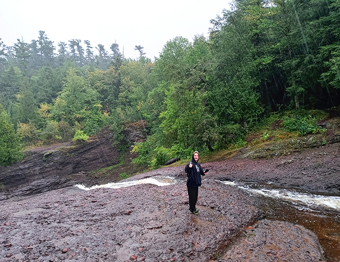 Waterfall wanderlust satisfied! A visitor takes in the magnificent view, becoming part of the landscape rather than just observing it.