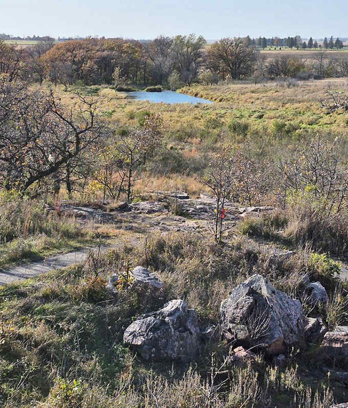 The prairie vista stretches toward the horizon, showcasing Minnesota's natural diversity from the vantage point of billion-year-old rocks.