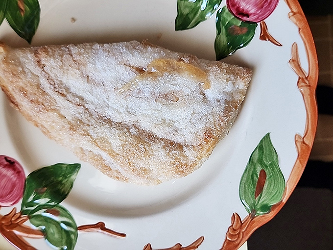 Warm, bubbly goodness topped with a scoop of cool cream. A perfect, comforting dessert that looks truly delicious.