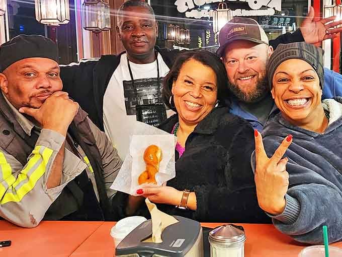 Happy customers showing off their prized possessions &ndash; at Avon, every donut purchase feels like winning a delicious lottery.