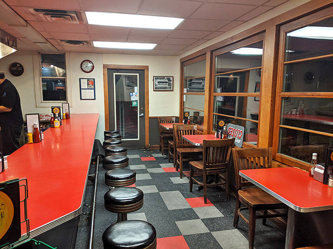 The dining area feels like a community living room where regulars and newcomers alike share space in the warm glow of authentic diner atmosphere.