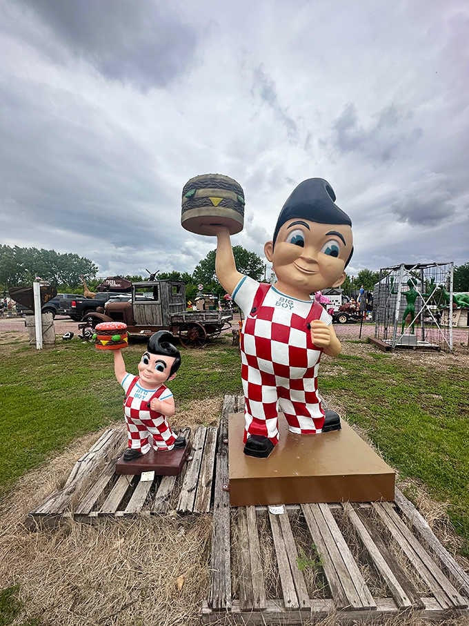 The iconic Big Boy restaurant mascot gets a countryside makeover, standing proudly with his burger while his mini-me counterpart mirrors the pose.