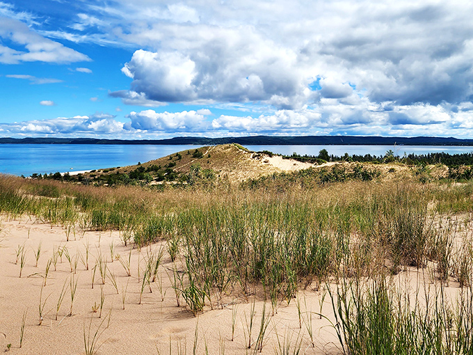 The dunes rise dramatically above Lake Michigan's impossibly blue waters. No filter needed &ndash; this is pure Michigan showing off.