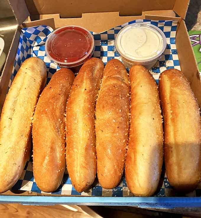 These breadsticks are the backup dancers to your pizza's main performance &ndash; perfectly golden, dusted with parmesan, and ready for their marinara dipping sauce spotlight.