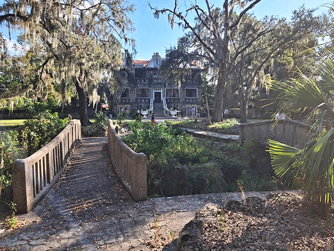 This arched stone bridge invites visitors across a garden depression toward the main house, like crossing into another world.