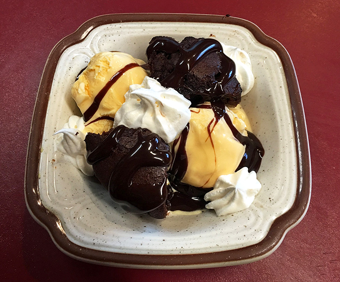 Brownie Sundae: Hot meets cold in this classic finale &ndash; a warm fudgy brownie crowned with ice cream that melts into all the right crevices.