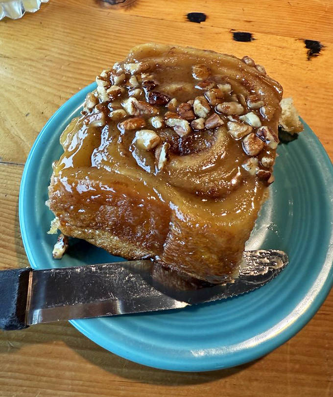 This isn't just any cinnamon roll&mdash;it's a spiral of joy, drenched in caramel and topped with pecans that'll haunt your dreams.