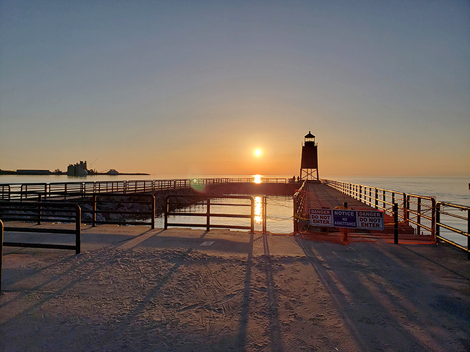 Sunset silhouettes transform the Charlevoix lighthouse into a dramatic sentinel against the day's final golden glow.