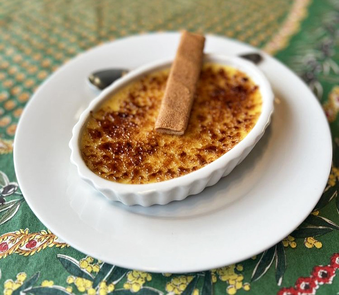 The cr&egrave;me br&ucirc;l&eacute;e's caramelized top gives that satisfying crack before revealing the silky custard beneath &ndash; dessert perfection in miniature form.
