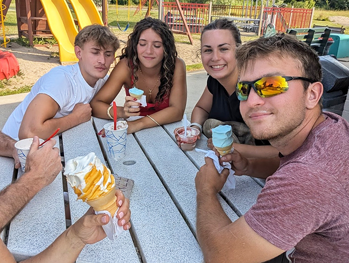 Summer memories in the making as friends gather around picnic tables, comparing custard choices like fine wine connoisseurs.