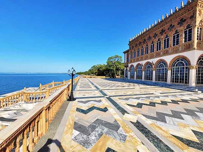 The terrace stretches along the bay with geometric marble patterns that make you want to play the world's fanciest game of hopscotch.