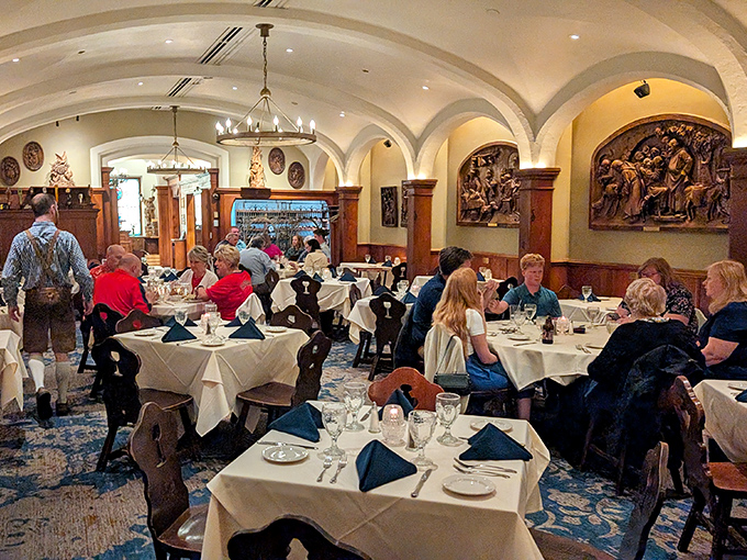Diners: Happy patrons enjoying the elegant dining room where white tablecloths, wooden chairs, and arched ceilings create the perfect setting for memorable meals.