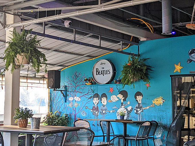 Hanging plants and vibrant murals transform this dining area into an artistic retreat where food becomes part of the experience.