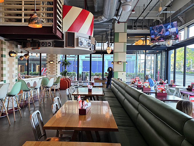 Modern meets nostalgic in this airy dining space, where green barstools and wooden tables create an atmosphere that's both trendy and timeless.