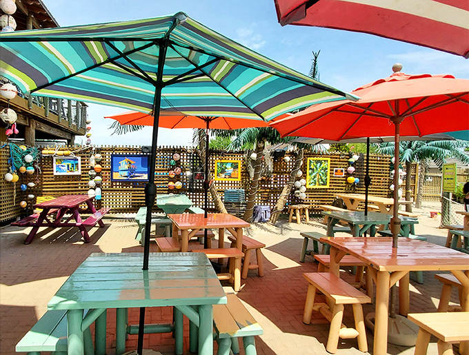 Technicolor tables under striped umbrellas create the perfect setting for pretending your lunch break is actually a week in Key West.