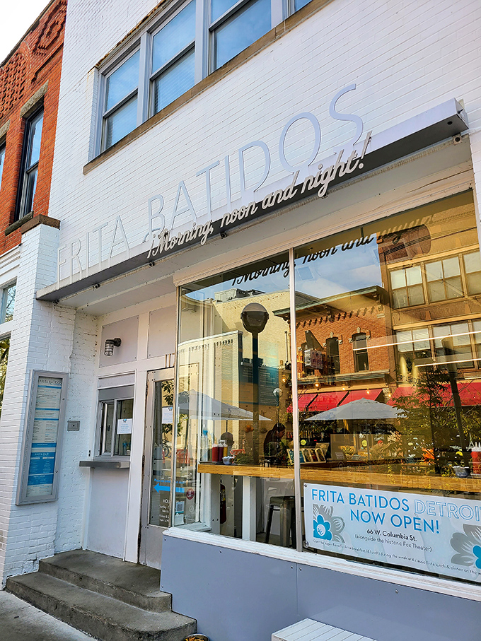 Frita Batidos' clean white storefront gives way to Cuban-inspired culinary magic inside, where burgers topped with crispy shoestring fries create addiction disguised as lunch.