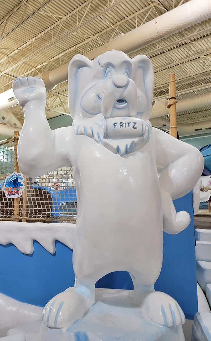 Fritz the friendly polar bear mascot stands guard with a welcoming wave, his cheerful presence adding to the Alpine theme throughout the park.