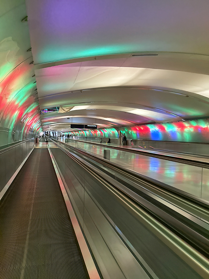 Each visit offers a different light experience &ndash; this emerald and crimson display transforms mundane airport infrastructure into an immersive art installation.
