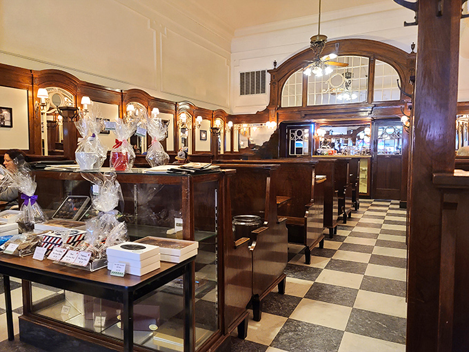 Black and white tiles lead the eye down a corridor of wooden booths and display cases – a checkerboard path to confectionery enlightenment.