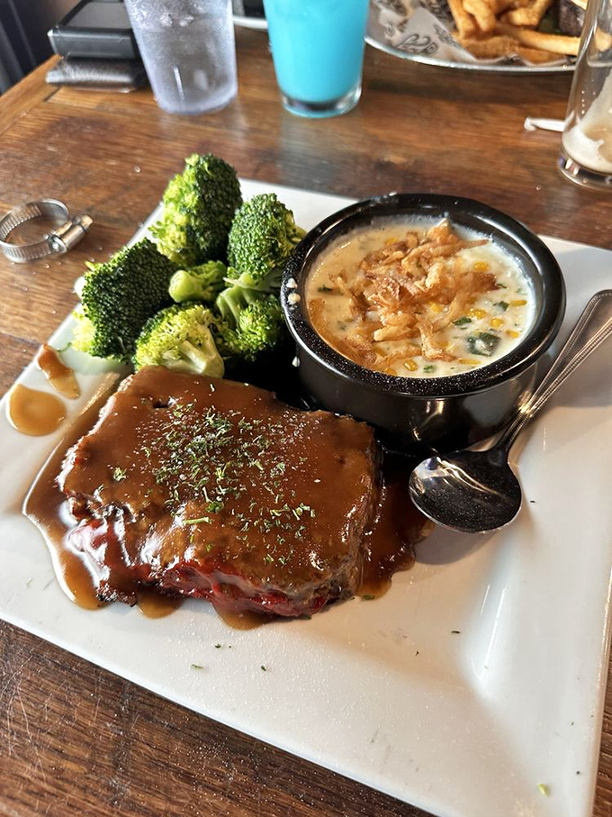 The meatloaf arrives looking like it drove straight out of grandma's kitchen, tender, savory, and paired with sides that complement without overshadowing.