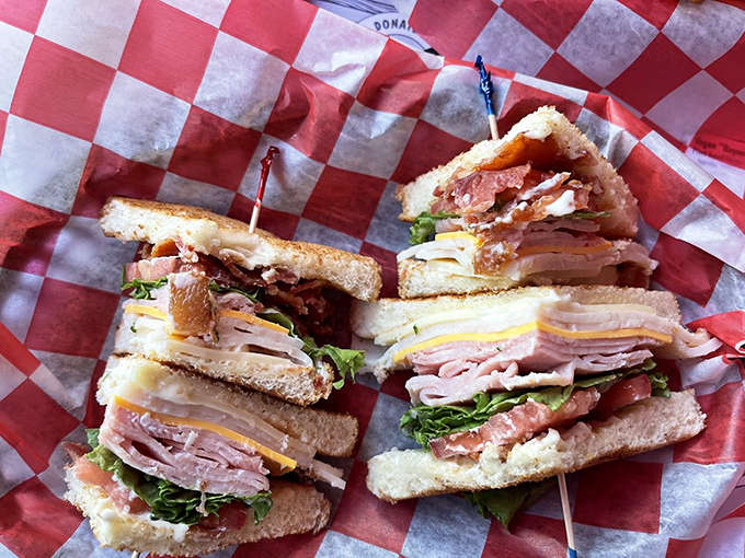 The club sandwich stands tall and proud, layers of meats and fixings creating a skyscraper of flavor that's worth the jaw stretch.