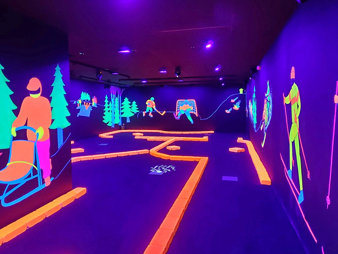 Hockey players and outdoor enthusiasts glow with fluorescent energy on this hole, celebrating Michigan's favorite recreational pastimes.