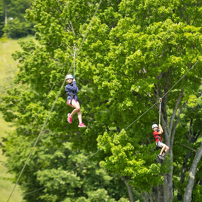 Young adventurers experience the rush of flying through summer's canopy. Childhood memories in the making, one zipline at a time!
