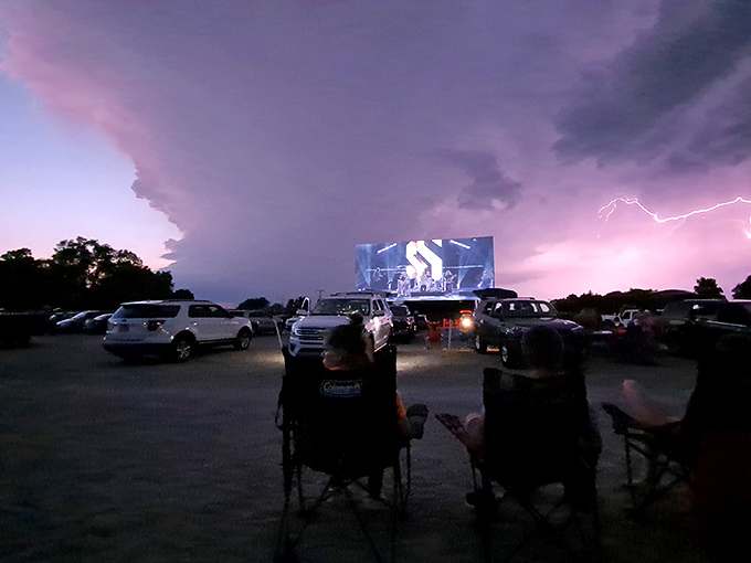 Even dramatic weather adds to the experience, lightning flashes in the distance while determined movie fans remain transfixed by the illuminated screen.