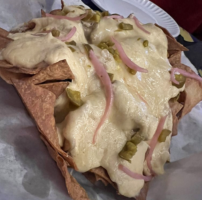 Nachos that defy gravity &ndash; layers of chips, melted cheese, pickled red onions and jalape&ntilde;os create a tower of flavor worth scaling.