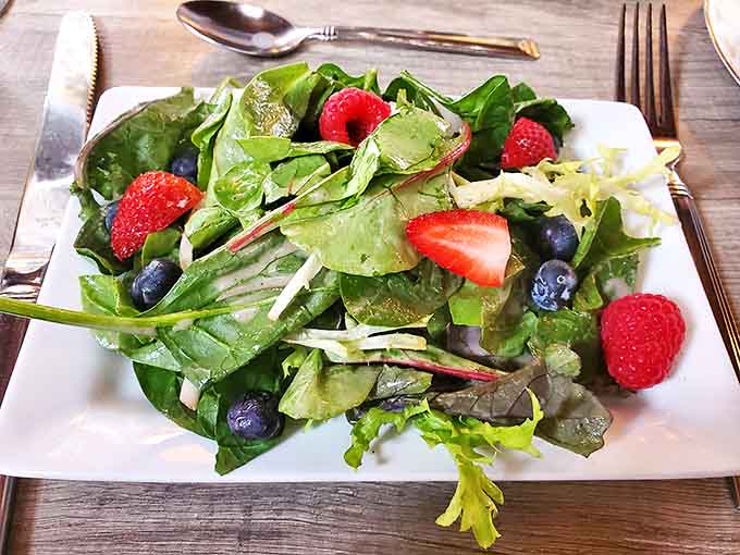 Garden-fresh greens dance with berries in this vibrant salad &ndash; proof that healthy eating can be both beautiful and delicious.