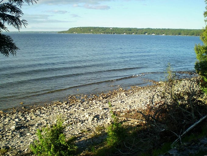 Tranquil waters of Green Bay stretch to the horizon, offering a moment of zen after conquering the trail's challenges.