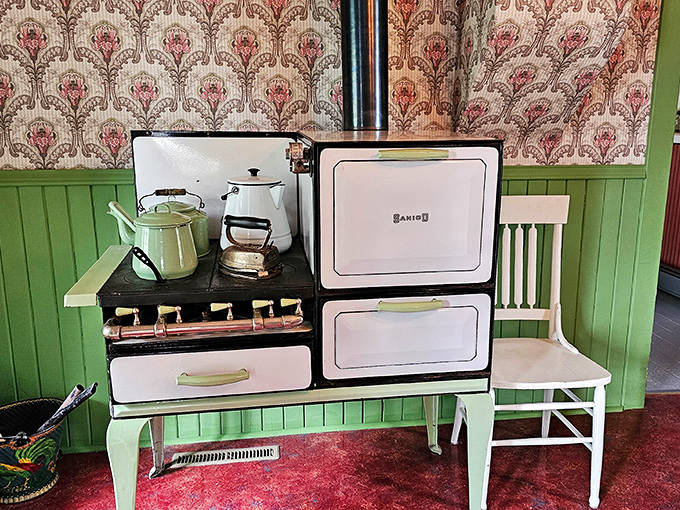 The vintage kitchen with its charming mint-green wainscoting and period appliances offers a glimpse into domestic life of the 1920s Midwest.