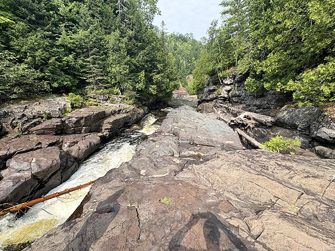 Time's patient sculptor: Centuries of rushing water have carved these smooth channels through some of North America's oldest exposed bedrock.el