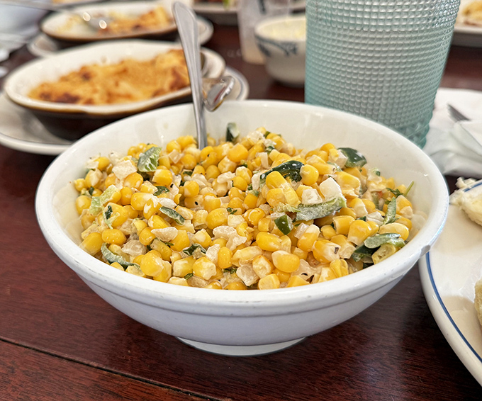 Fresh sweet corn salad provides a bright, summery counterpoint to the richer offerings &ndash; the kind of side that starts as obligation but ends as favorite.