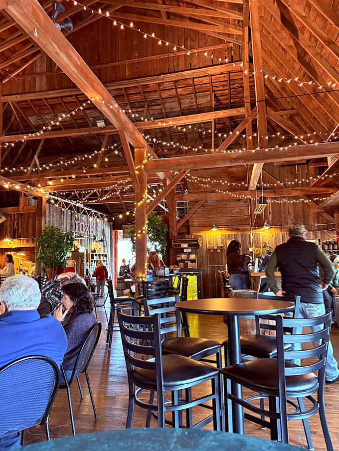 Inside the barn, modern furnishings complement historic architecture, creating intimate spaces for wine lovers to gather and connect.