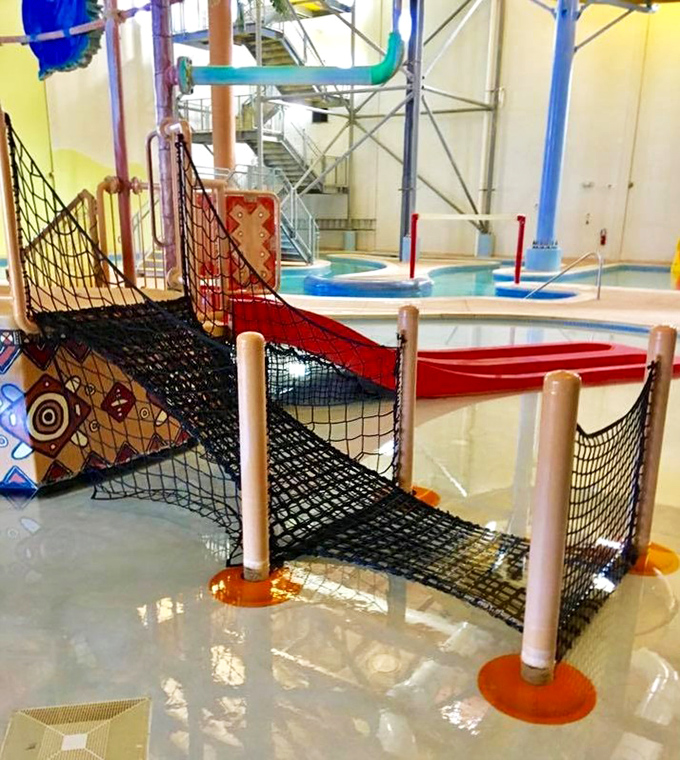 The aquatic play structures combine climbing challenges with water features, creating multi-level entertainment for energetic explorers.