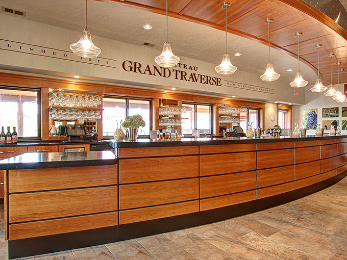 The elegant curved wooden bar invites visitors to belly up for a tasting journey through Michigan's finest cool-climate wines.
