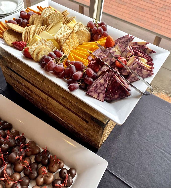 A charcuterie board that understands the assignment, loaded with meats, cheeses, and fruits that pair perfectly with good company and better views.