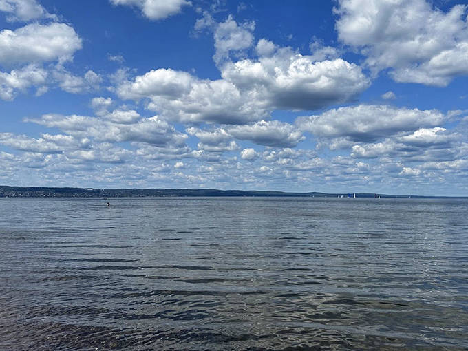 Even on overcast days, Park Point Beach offers dramatic beauty as clouds create an ever-changing canvas above the water.