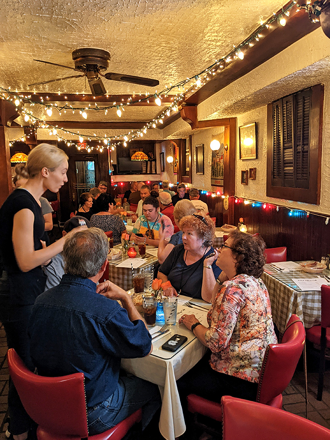 The dining room buzzes with conversation as servers navigate between closely packed tables, creating the kind of communal atmosphere that's increasingly rare in modern restaurants.