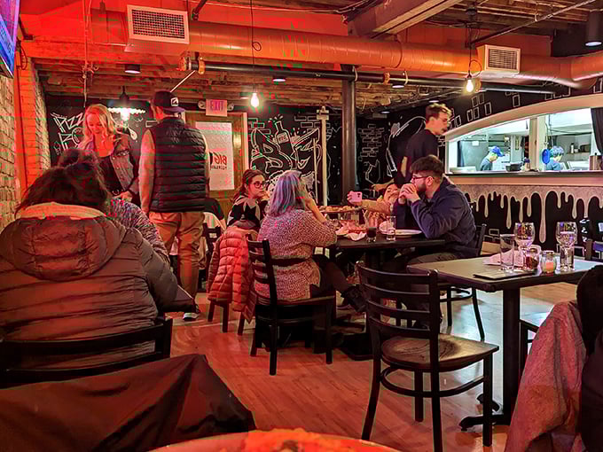 The dining room buzzes with conversation and laughter &ndash; strangers becoming friends over shared tables and mutual appreciation for exceptional pizza.