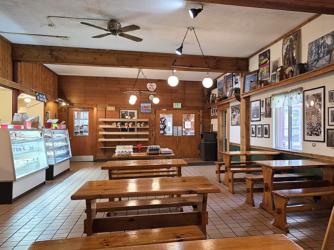Simple wooden tables and warm lighting create a dining space that feels like home, if home had better donuts and less judgment about seconds.