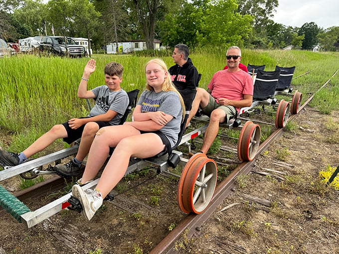 Smiles and waves capture the simple pleasure of rail biking, where the journey becomes as memorable as any destination.