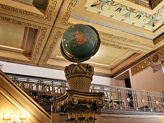 This ornate globe, perched atop an elaborate pedestal, represents the universal reach of Masonic principles beneath a ceiling of artistic wonder.