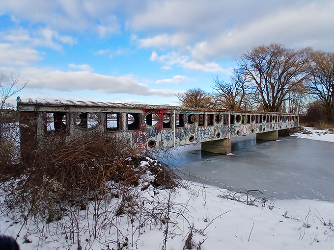 This graffiti-covered pedestrian bridge represents Detroit's blend of urban grit and artistic expression, connecting island paths with colorful personality.