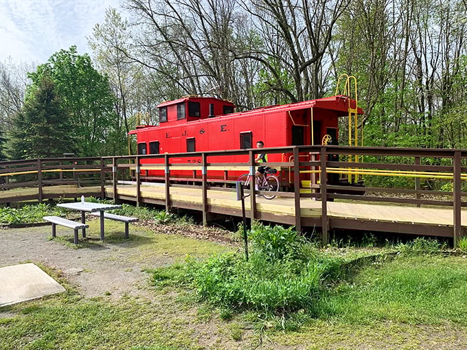 This cheerful red caboose isn't just a historical landmark &ndash; it's a vibrant reminder of the railroad heritage that birthed the trail.