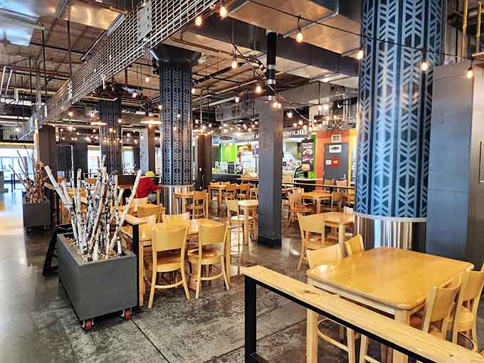 The market's central gathering space &ndash; where strangers become temporary tablemates united by the universal language of "that looks delicious!"