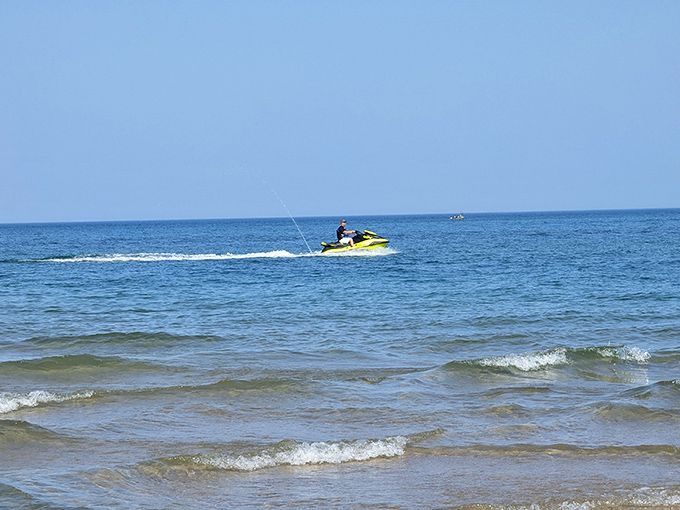 Thrill-seekers carve across Lake Michigan's surface on jet skis, creating memories at 40 miles per hour.