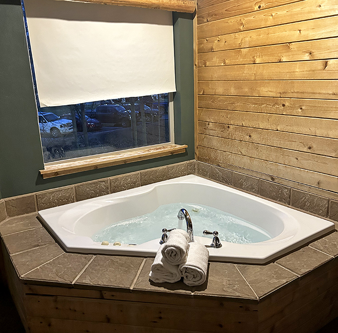 After hours of public splashing, retreat to a private corner jetted tub nestled against rustic wood paneling for peaceful soaking.