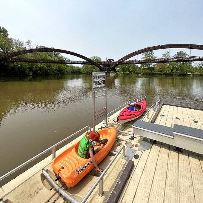 Colorful kayaks await adventure-seekers at the launch dock, promising up-close perspectives of the architectural marvel from water level.